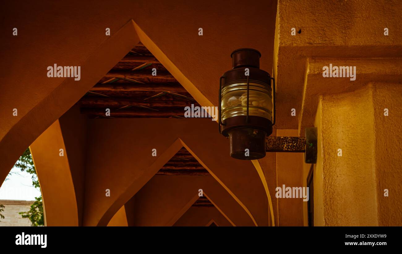 old lamp on the wall, eastern arches, street of ethnic village of ...