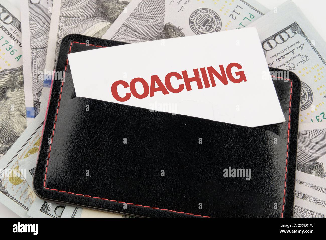 COACHING written on business cards in a business card holder against ...