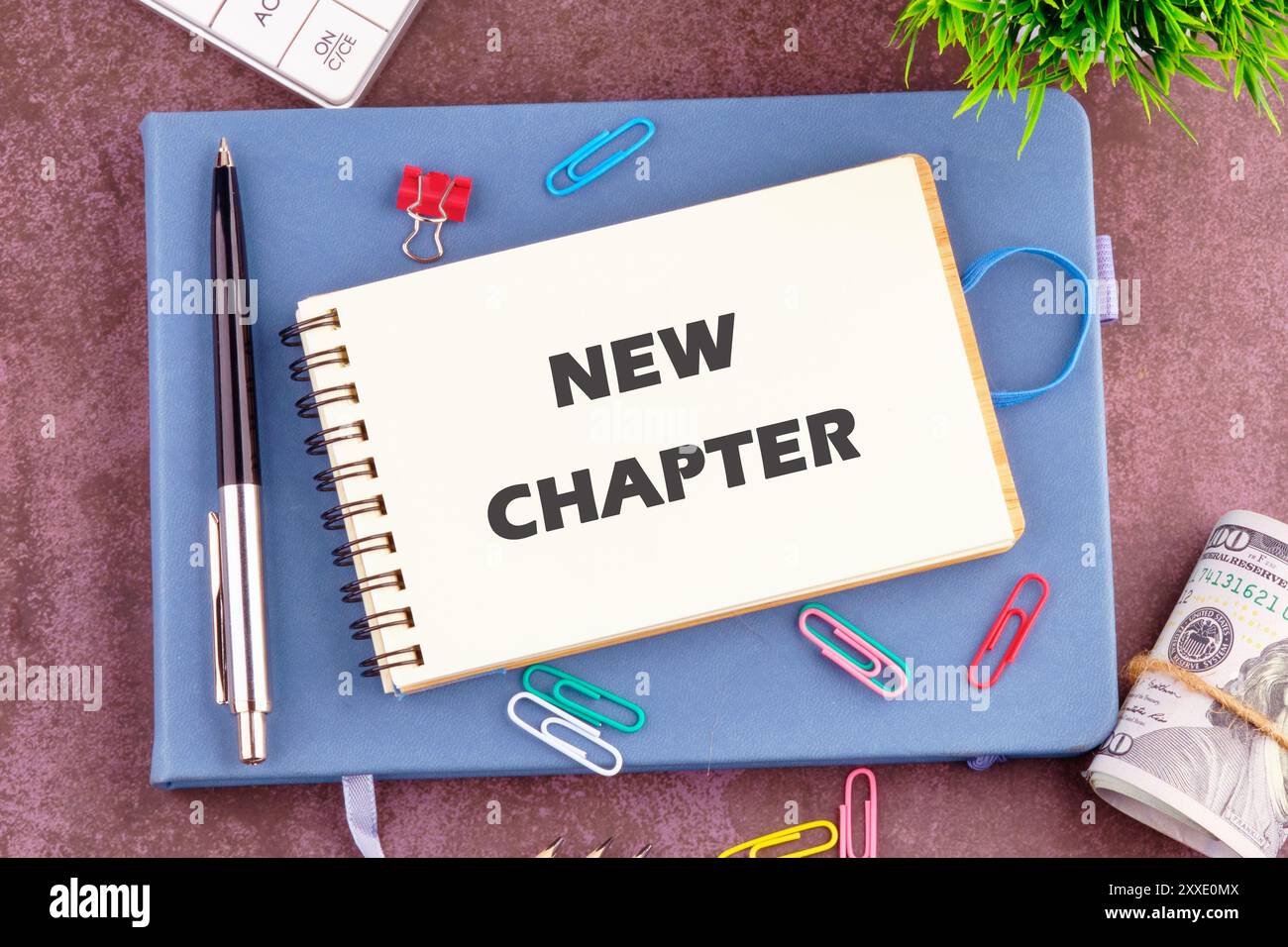 Text sign showing the NEW CHAPTER in the notebook. View from above ...