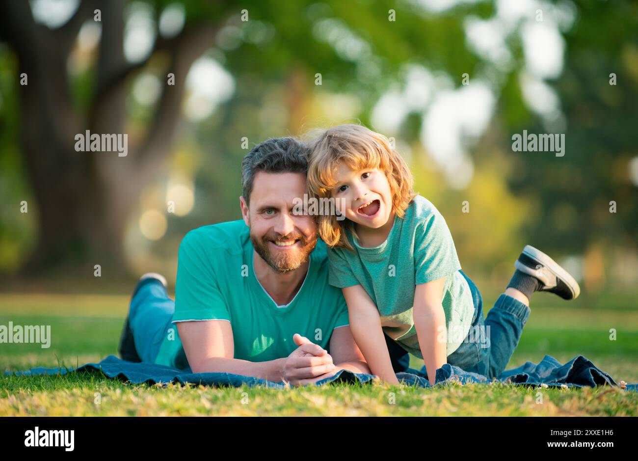 Father and son relaxing on nature in park. Summer family vacation Stock ...