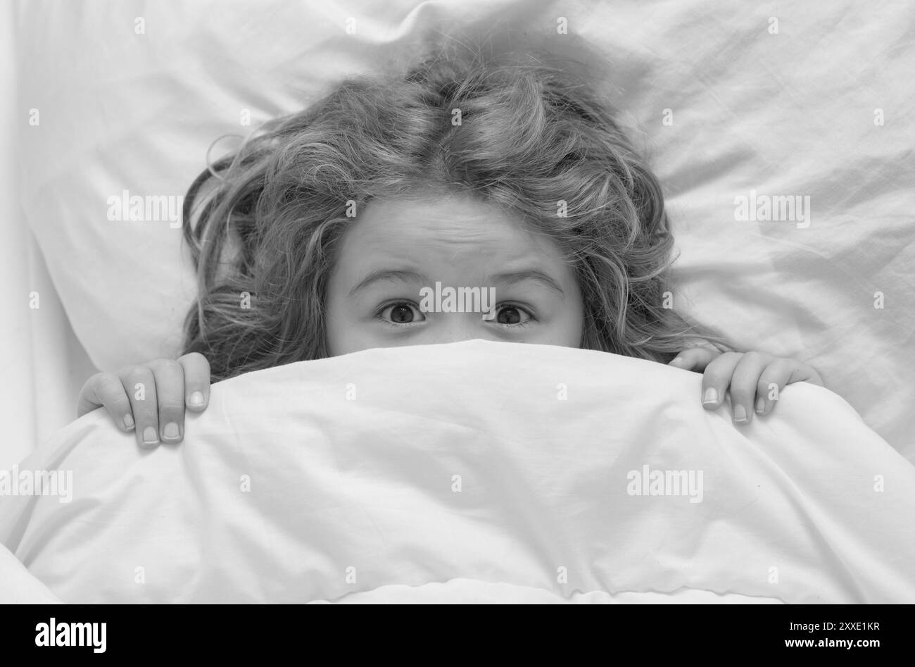 Nightmare kids, child hiding under white blanket, top view. Scared boy ...