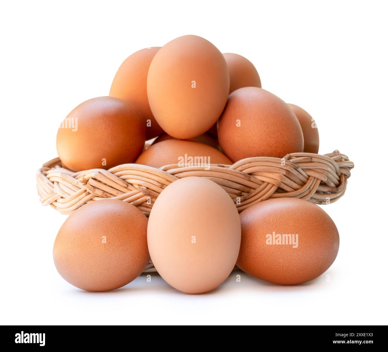 Fresh brown chicken eggs in stack in wicker basket are isolated on ...