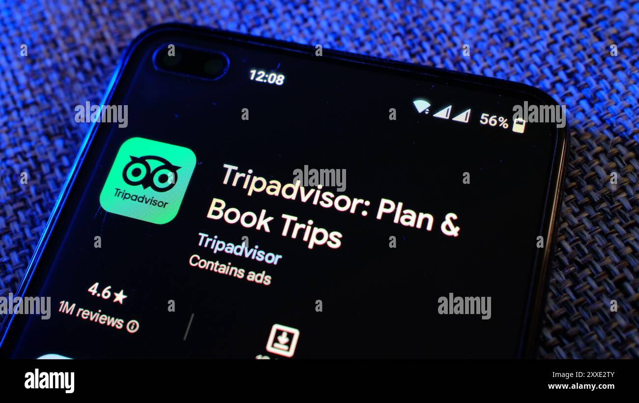 Tripadvisor app for plan and book trips in play store page on mobile phone display. London, UK ...