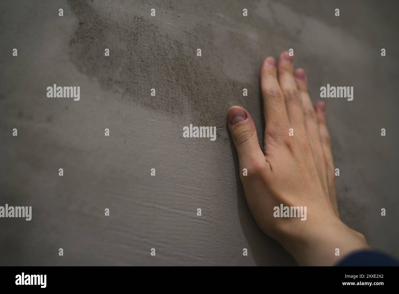 closeup young man hand touching concrete wall, construction works Stock ...
