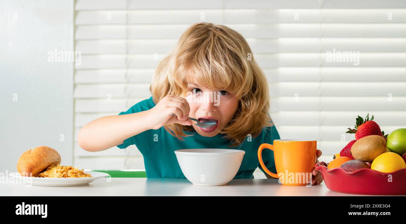 Hunger, appetite concept. Funny blonde little boy having breakfast ...