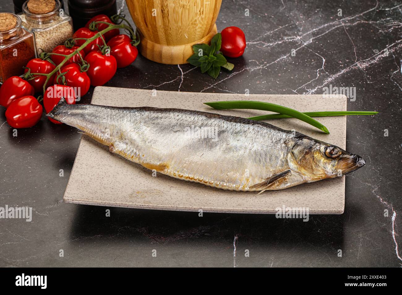 Whole raw salted herring fish in the plate Stock Photo - Alamy
