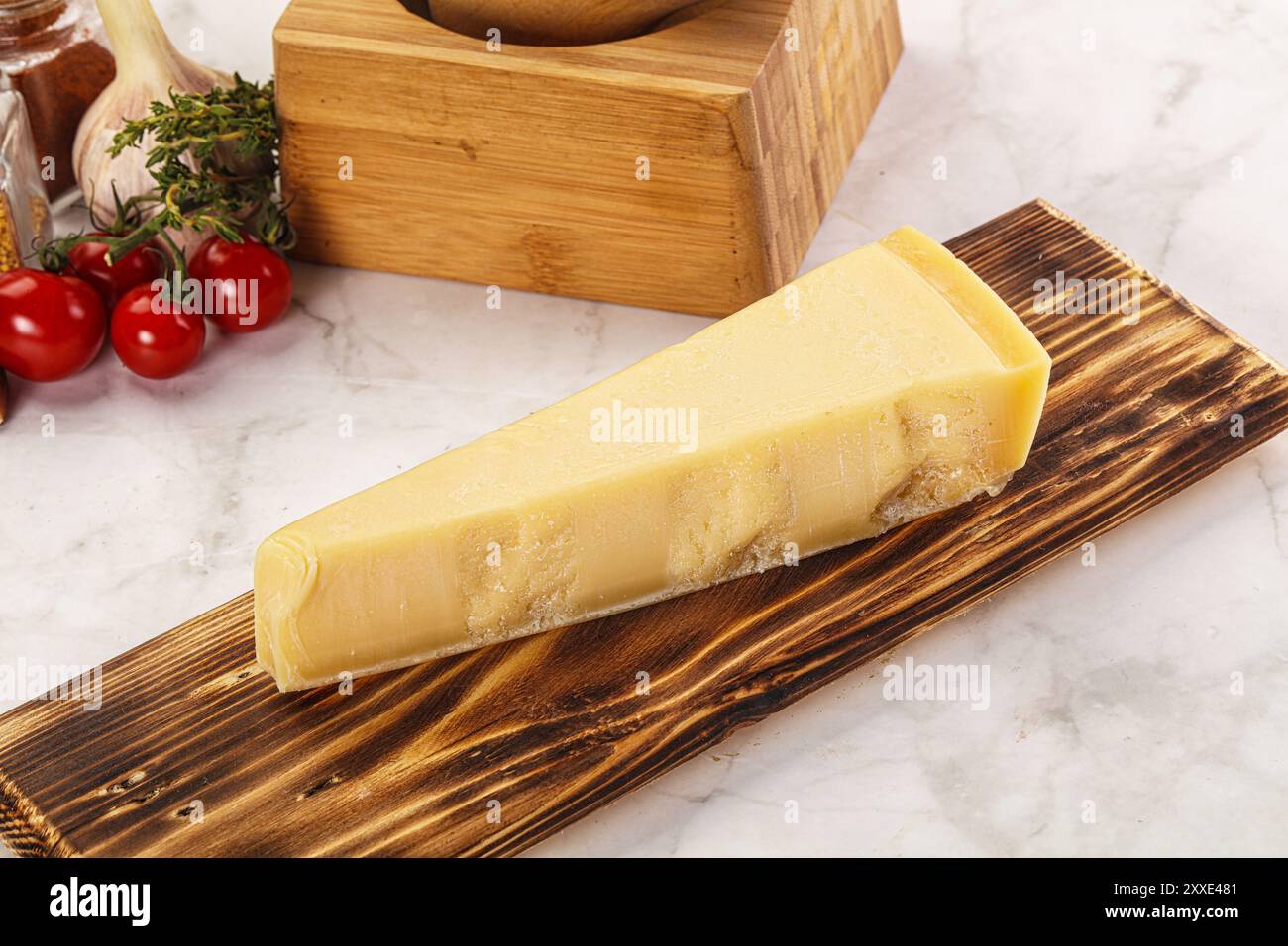 Hard parmesan cheese piece triangle over board Stock Photo - Alamy