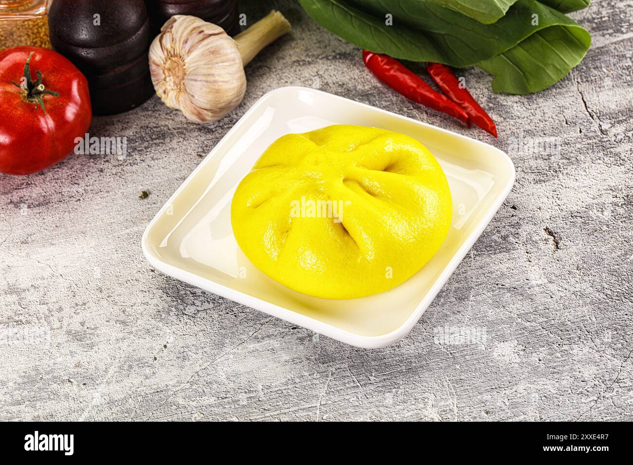 Asian stuffed steamed yellow Bun Bao Stock Photo - Alamy