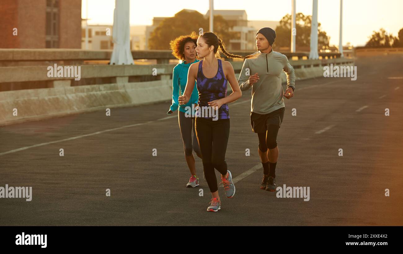 City, street and people running together for fitness, evening training or commitment for healthy ...