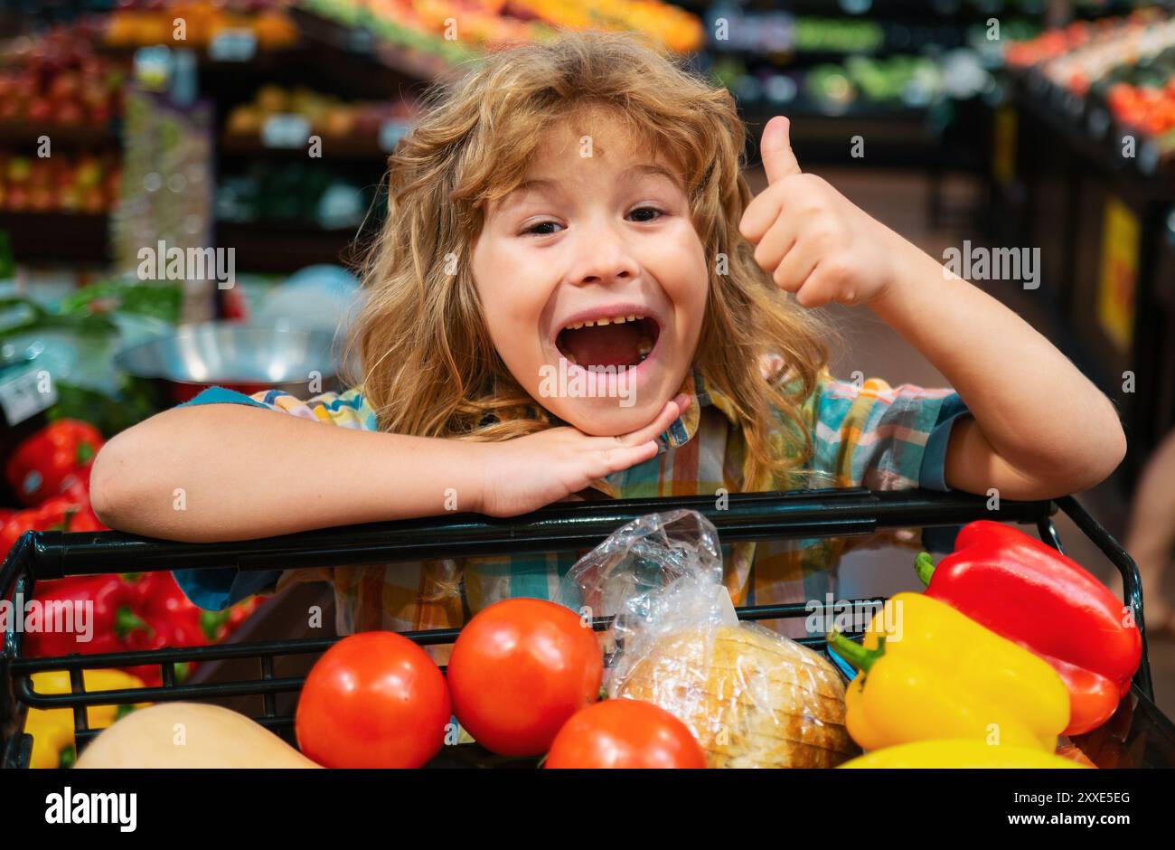 Sale, consumerism and child. Excited kid with food in shopping cart at ...