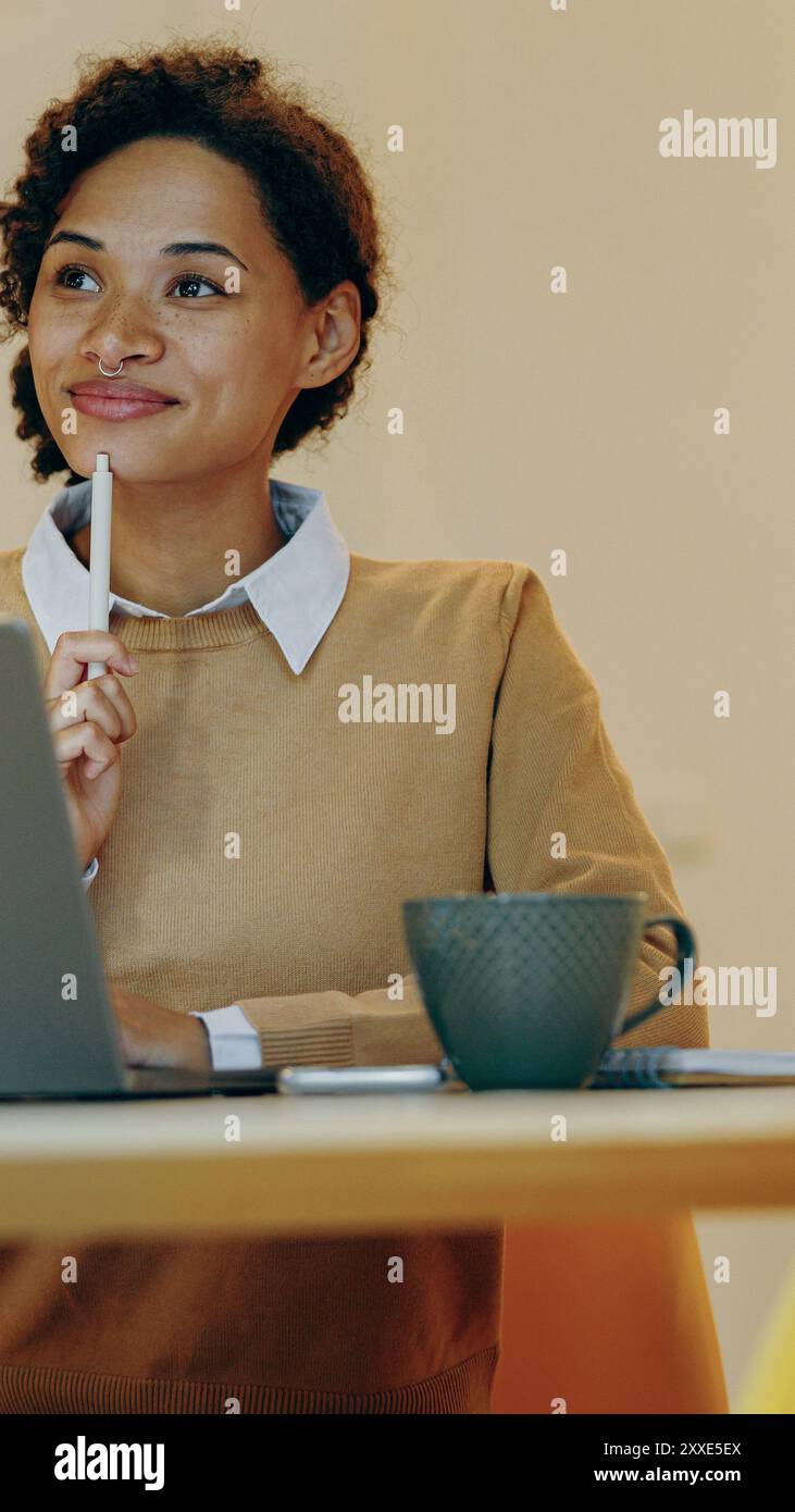 A thoughtful and contemplative woman is engaged in work within a modern ...