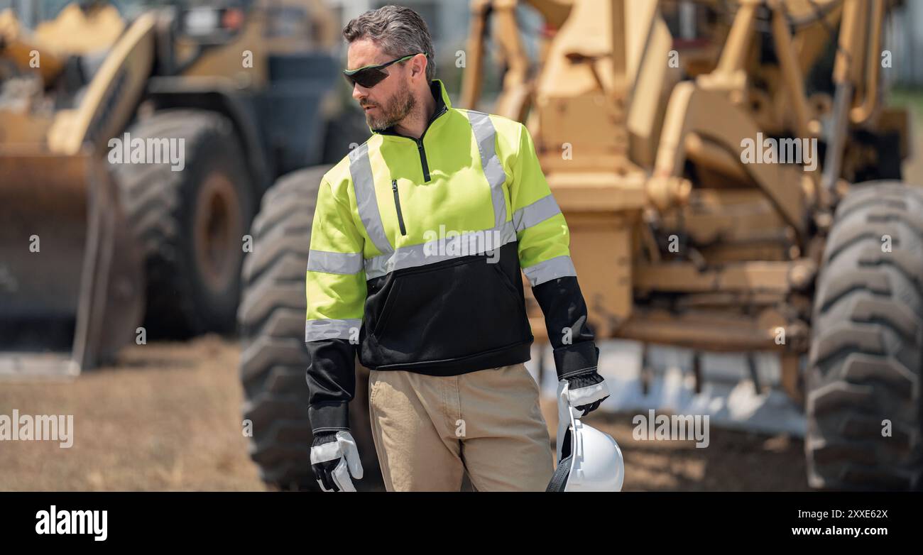 Worker with bulldozer on site construction. Man excavator worker ...