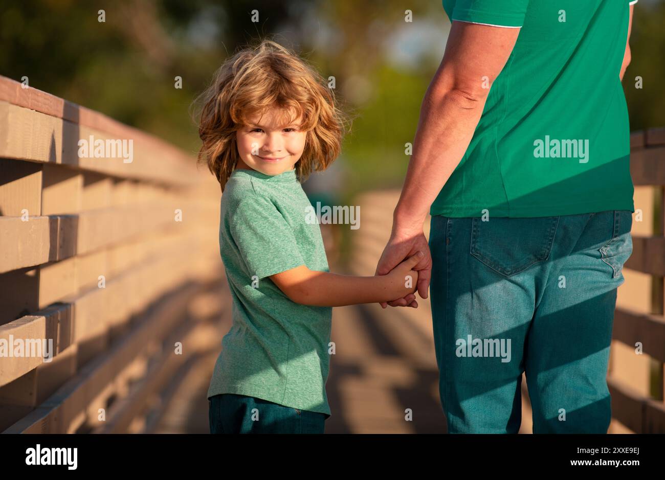 Friendly family. Happy father and son. Son stretching out hands father ...
