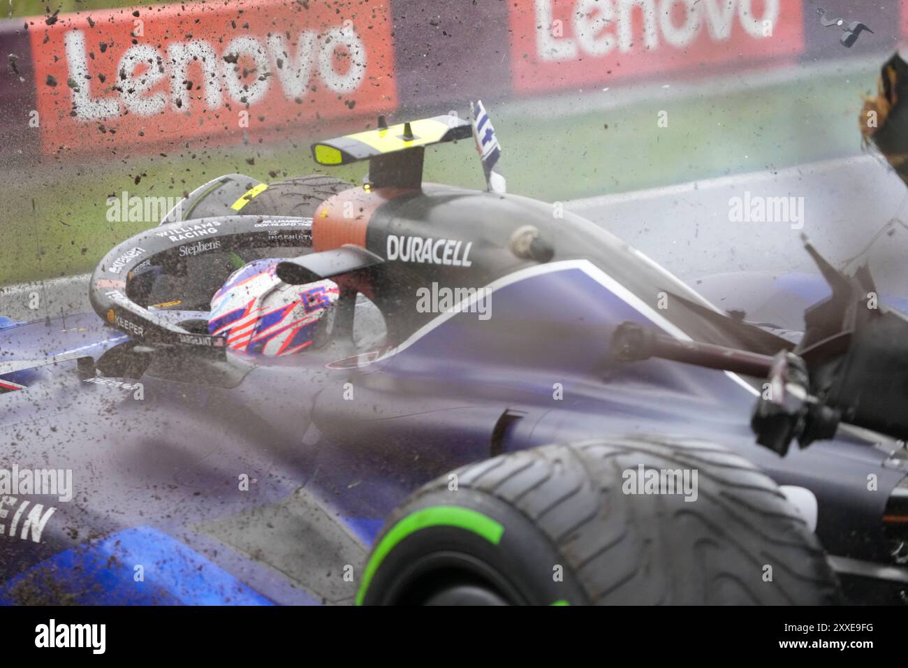 Debris flies as Williams driver Logan Sargeant of the US crashes during ...