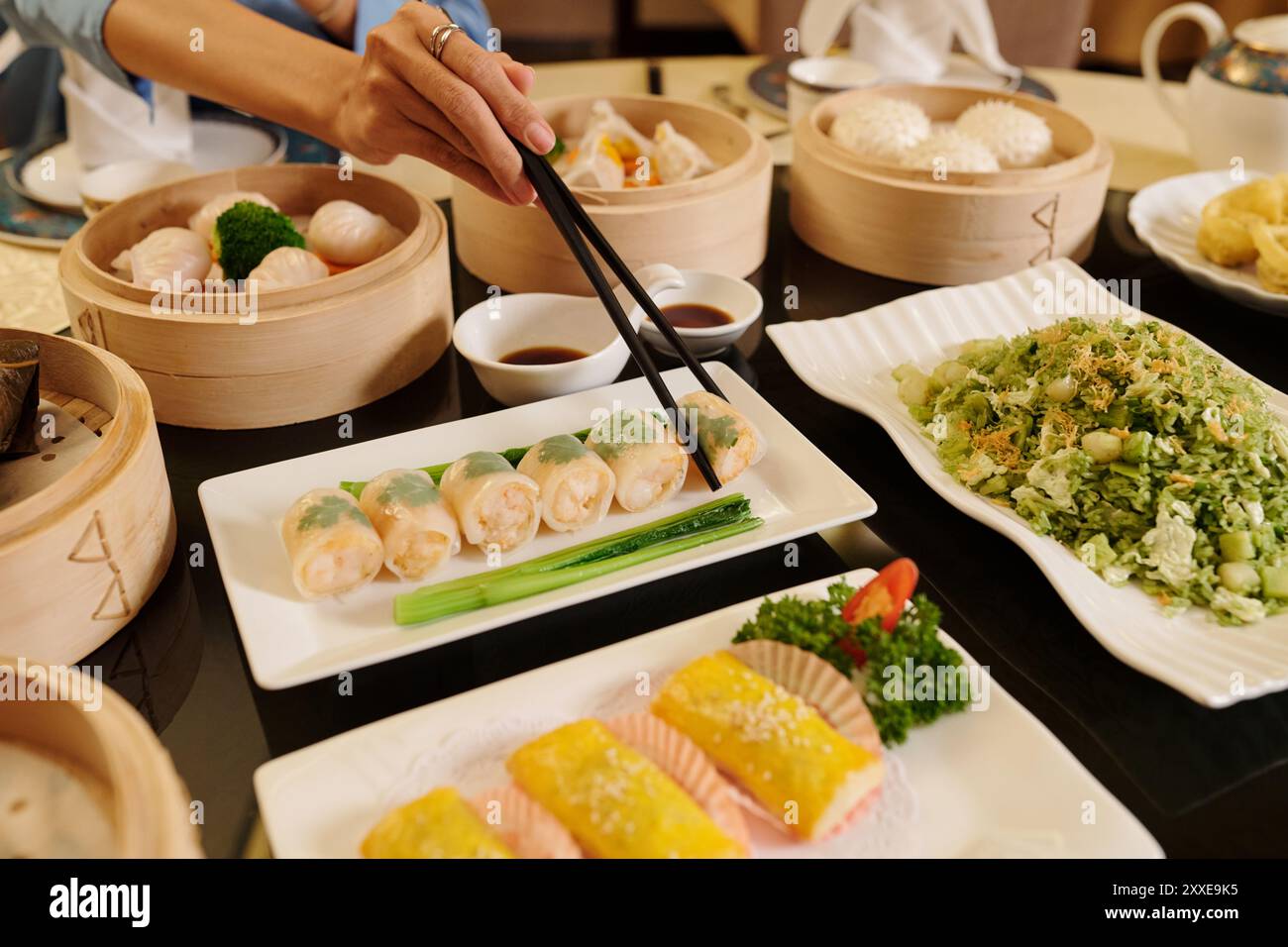 Woman Eating Rolls With Sticks Stock Photo - Alamy
