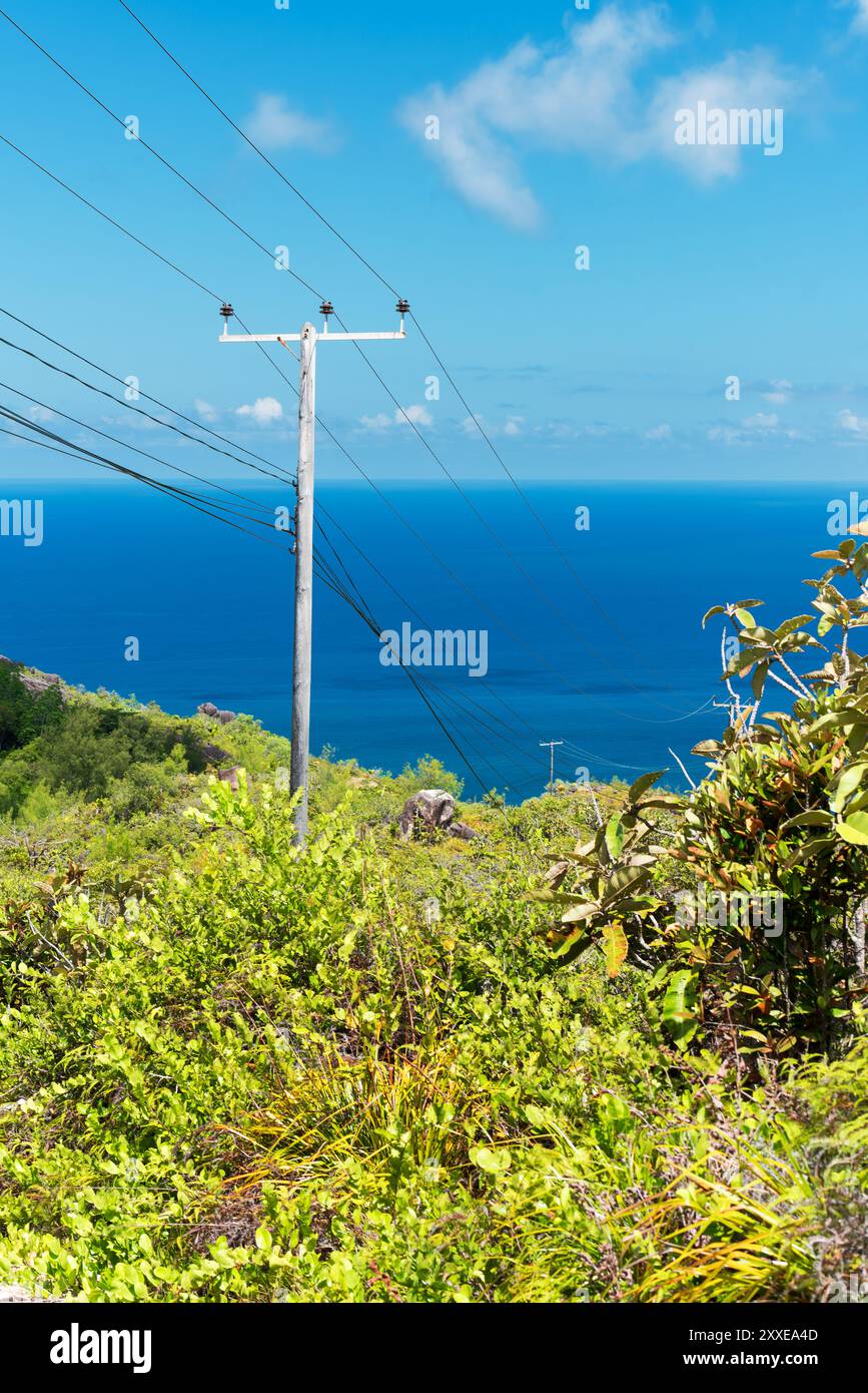 Telegraph poles on a hill in the sunny Seychelles Stock Photo - Alamy