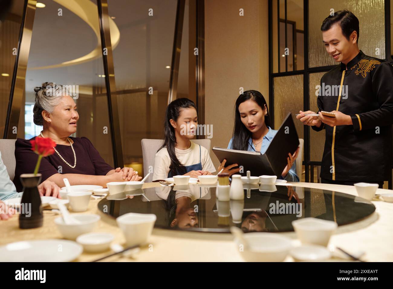 Family Reading Menu And Making Order Stock Photo - Alamy