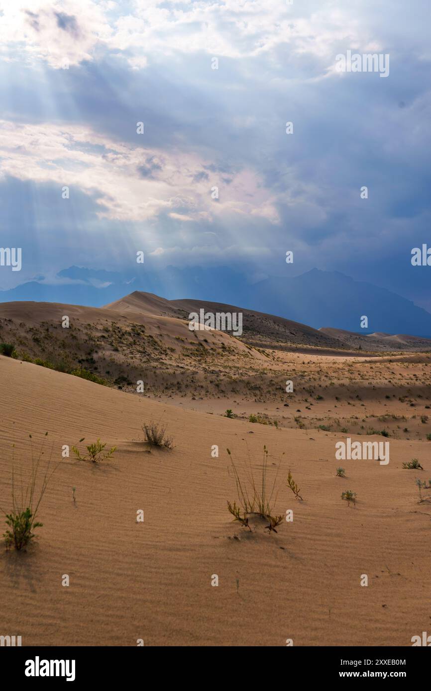 Sun rays pierce through dramatic clouds, illuminating the rolling ...