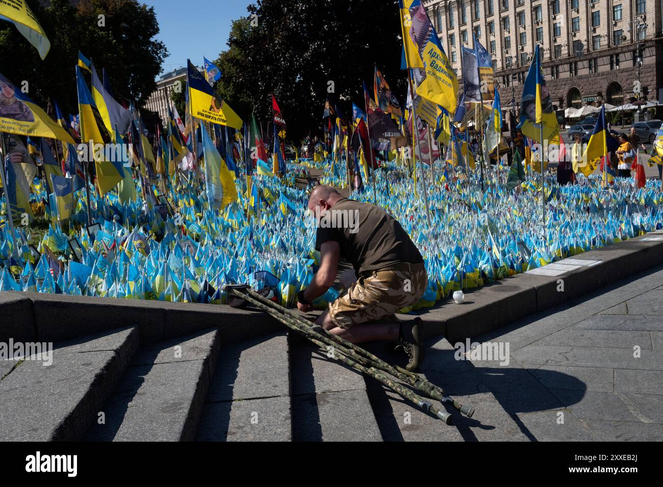 A veteran pays his respect at a makeshift memorial for fallen Ukrainian ...