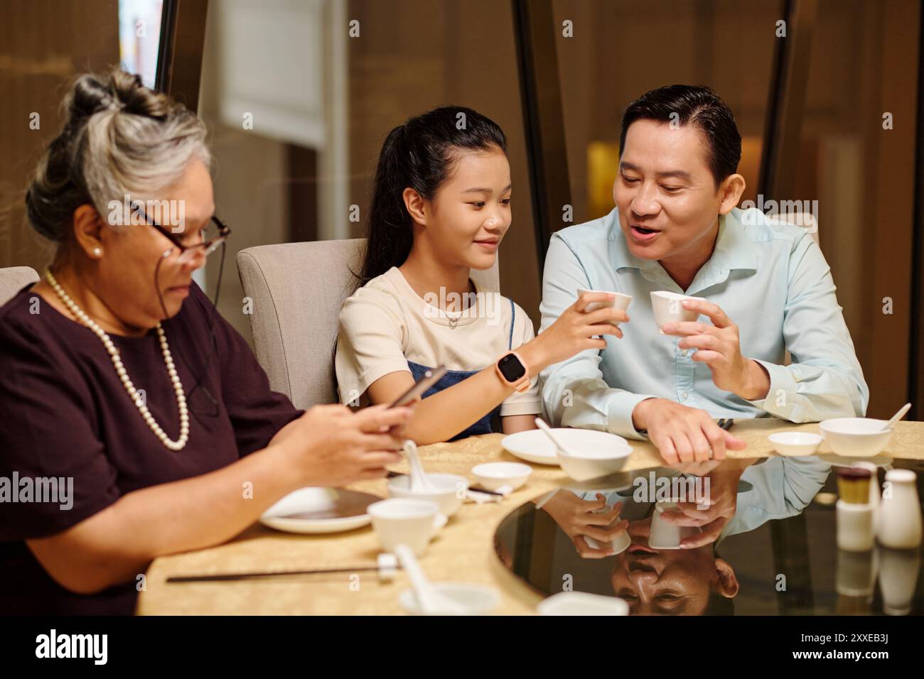 Family Waiting For Dinner In The Restaurant Stock Photo - Alamy