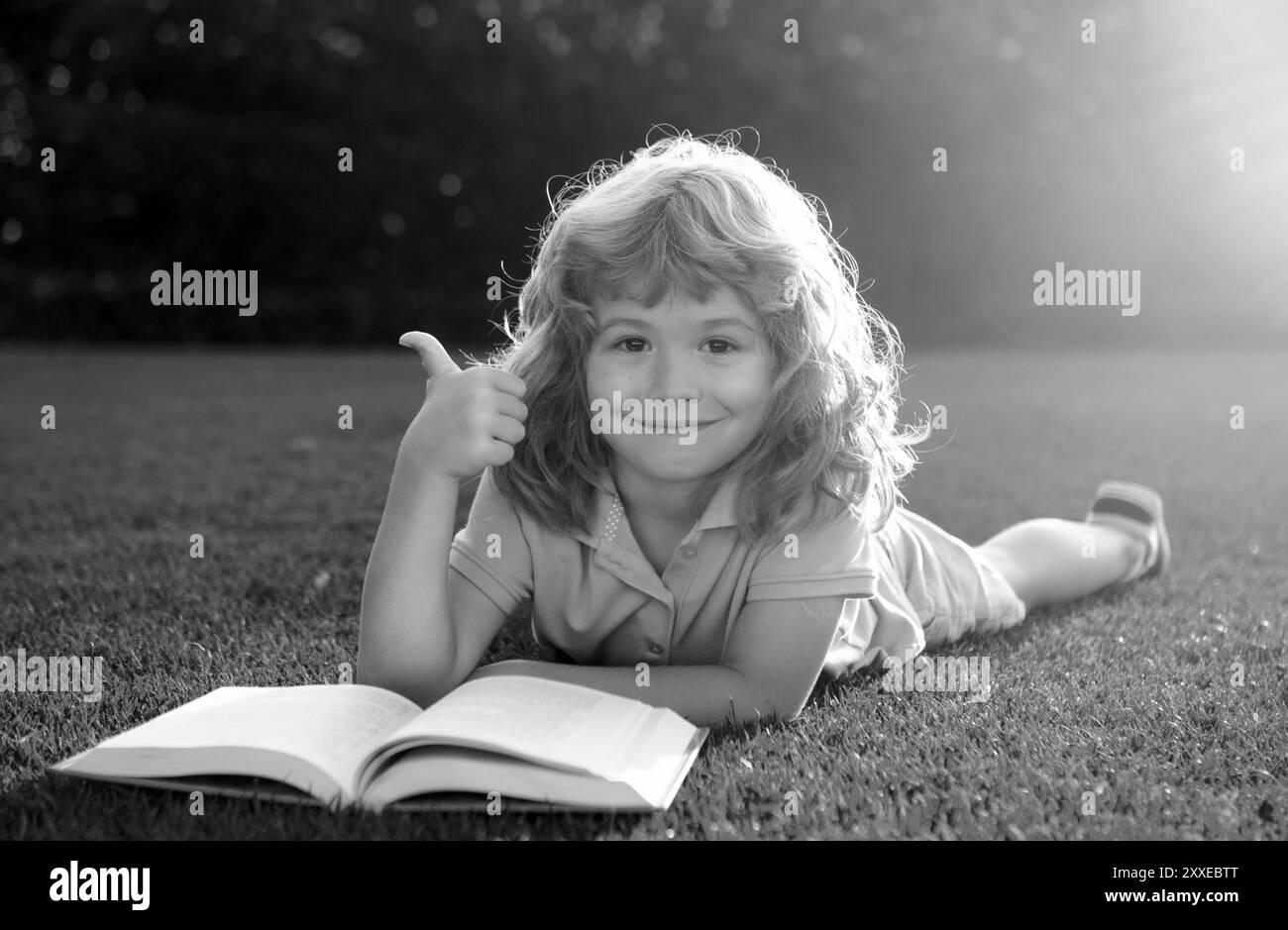 Kid read book. Child school with thumbs up and outdoor education ...