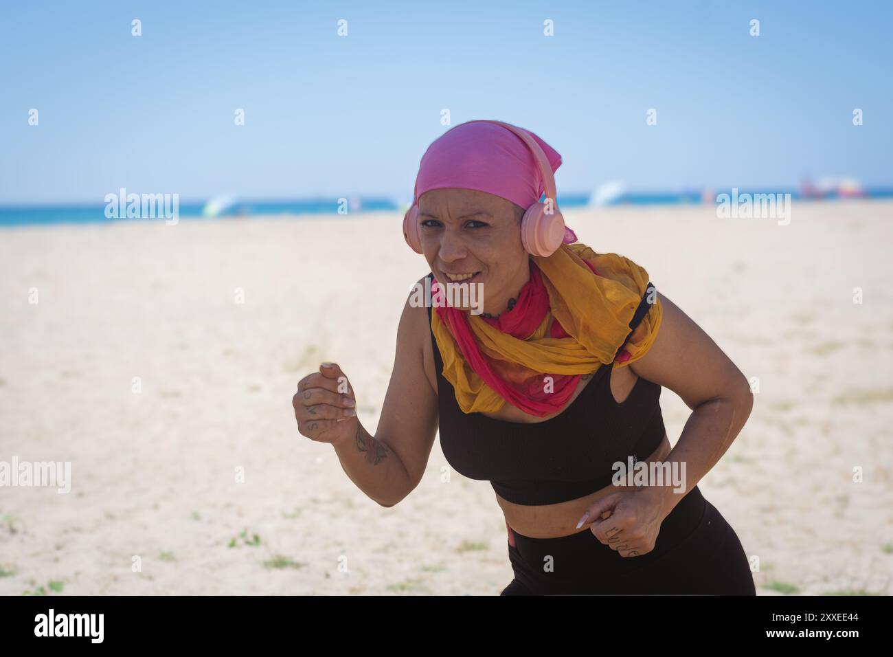 Close-up of a resilient middle-aged woman with cancer running on the ...