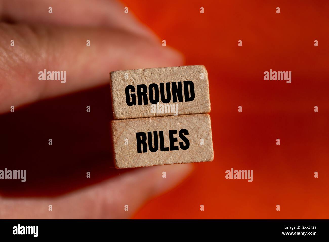 Ground rules message written on wooden blocks with orange background ...