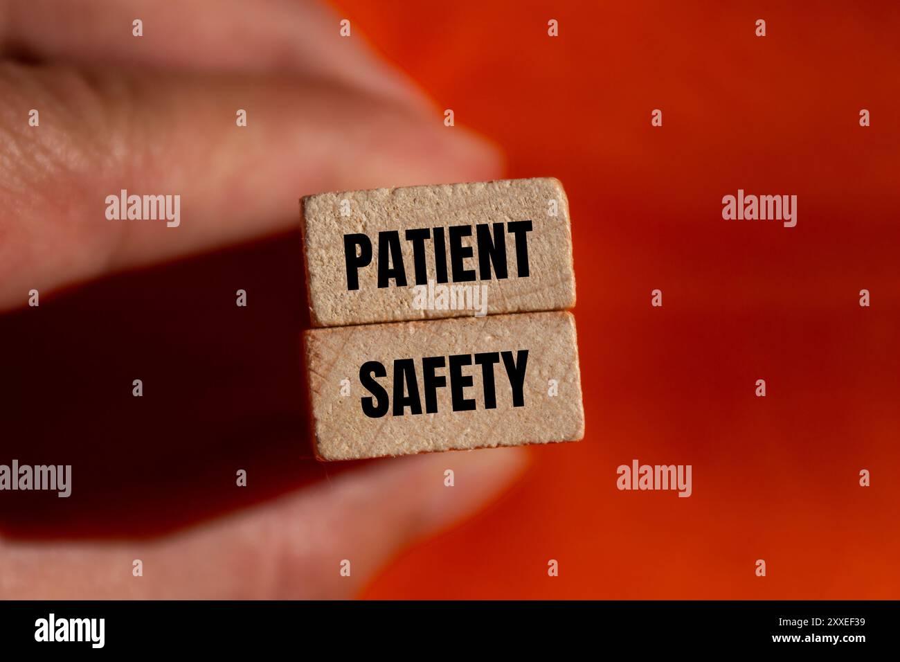 Patient safety message written on wooden blocks with orange background ...