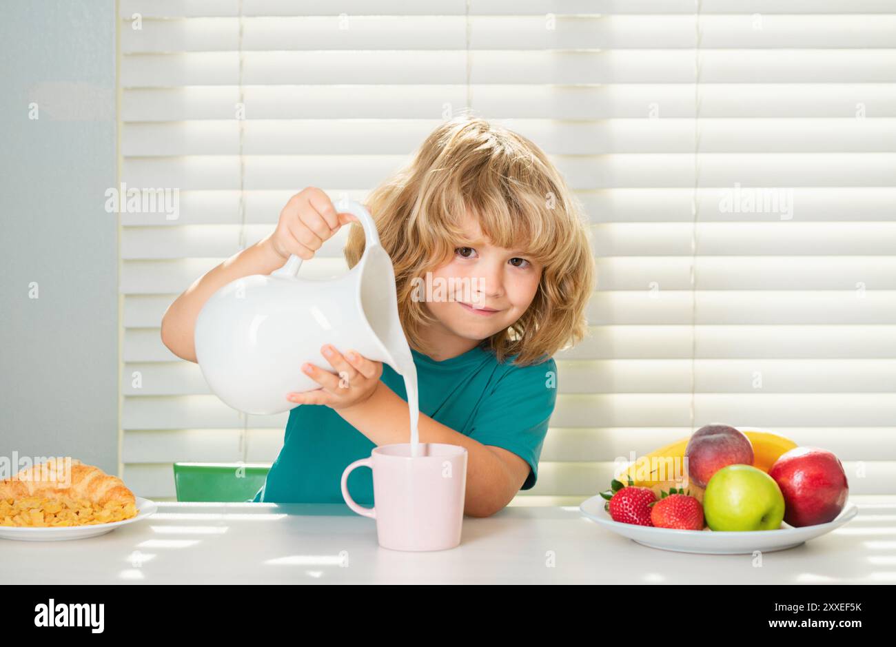 Kid boy pouring whole cows milk. Portrait of child eat fresh healthy ...