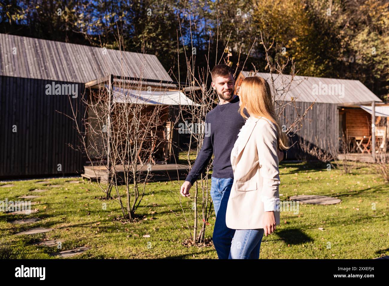 Loving couple relaxing walking through glamping center, enjoying nature ...