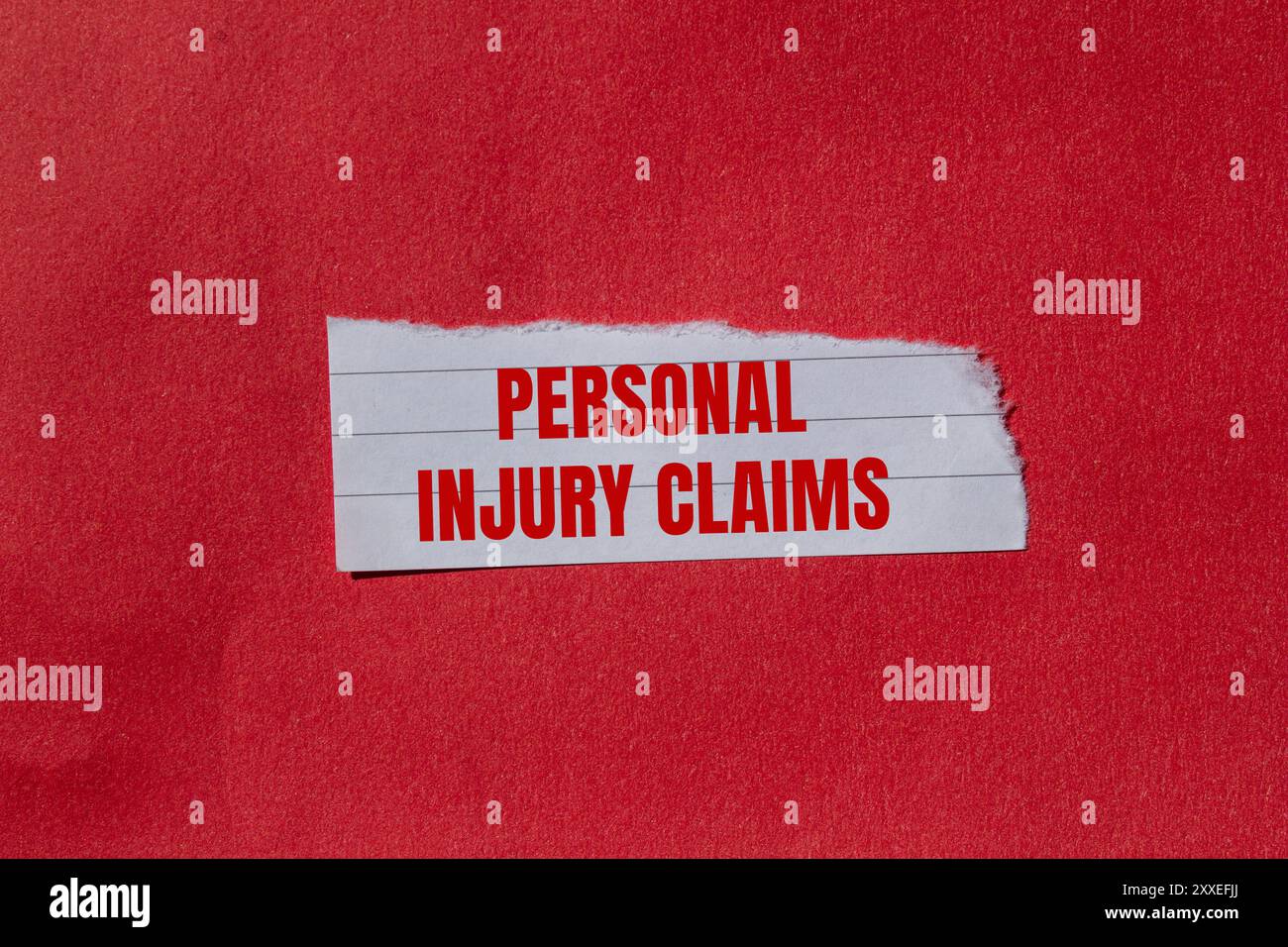 Personal injury claims message written on ripped torn paper piece with ...