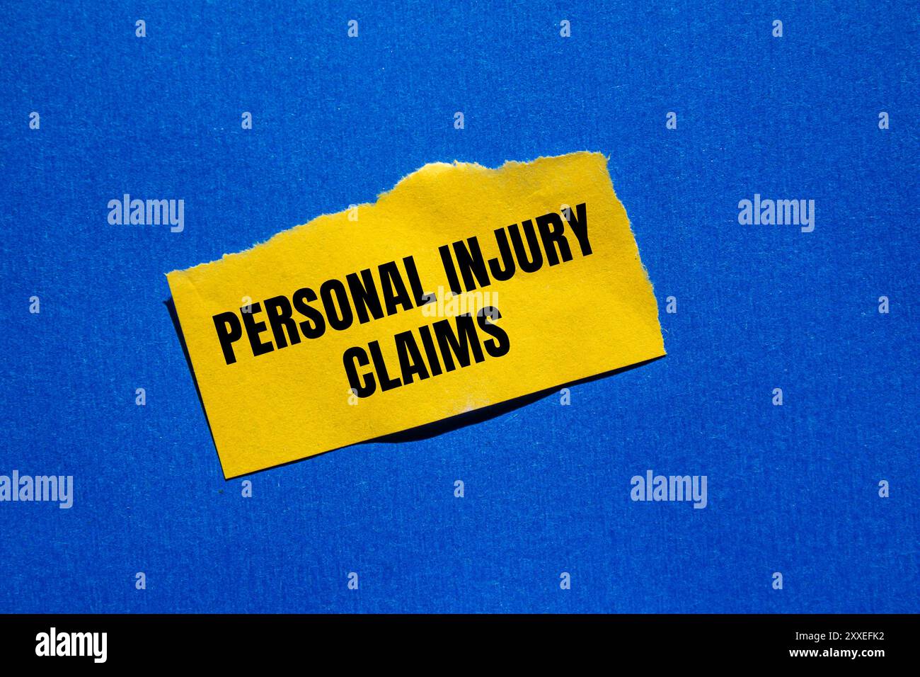 Personal injury claims message written on ripped torn yellow paper ...