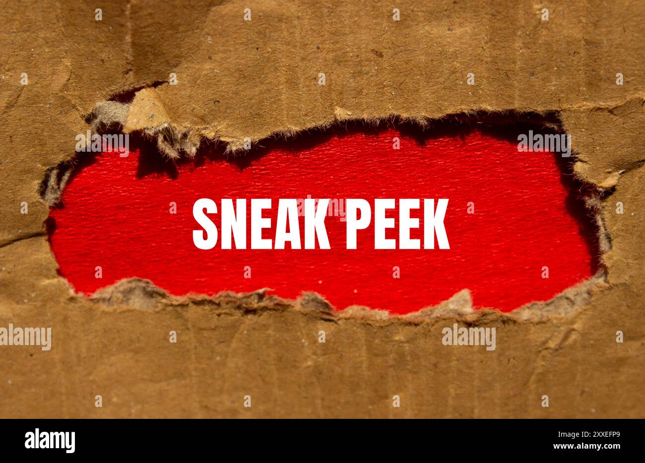 Sneak peek message written on torn cardboard paper with red background ...
