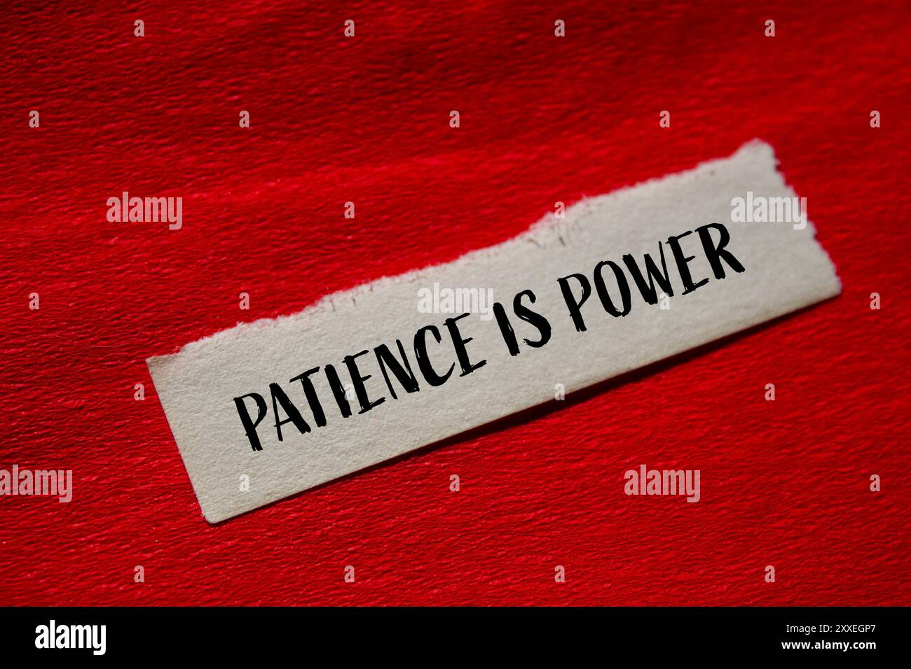 Patience is power message written on torn paper with red background ...