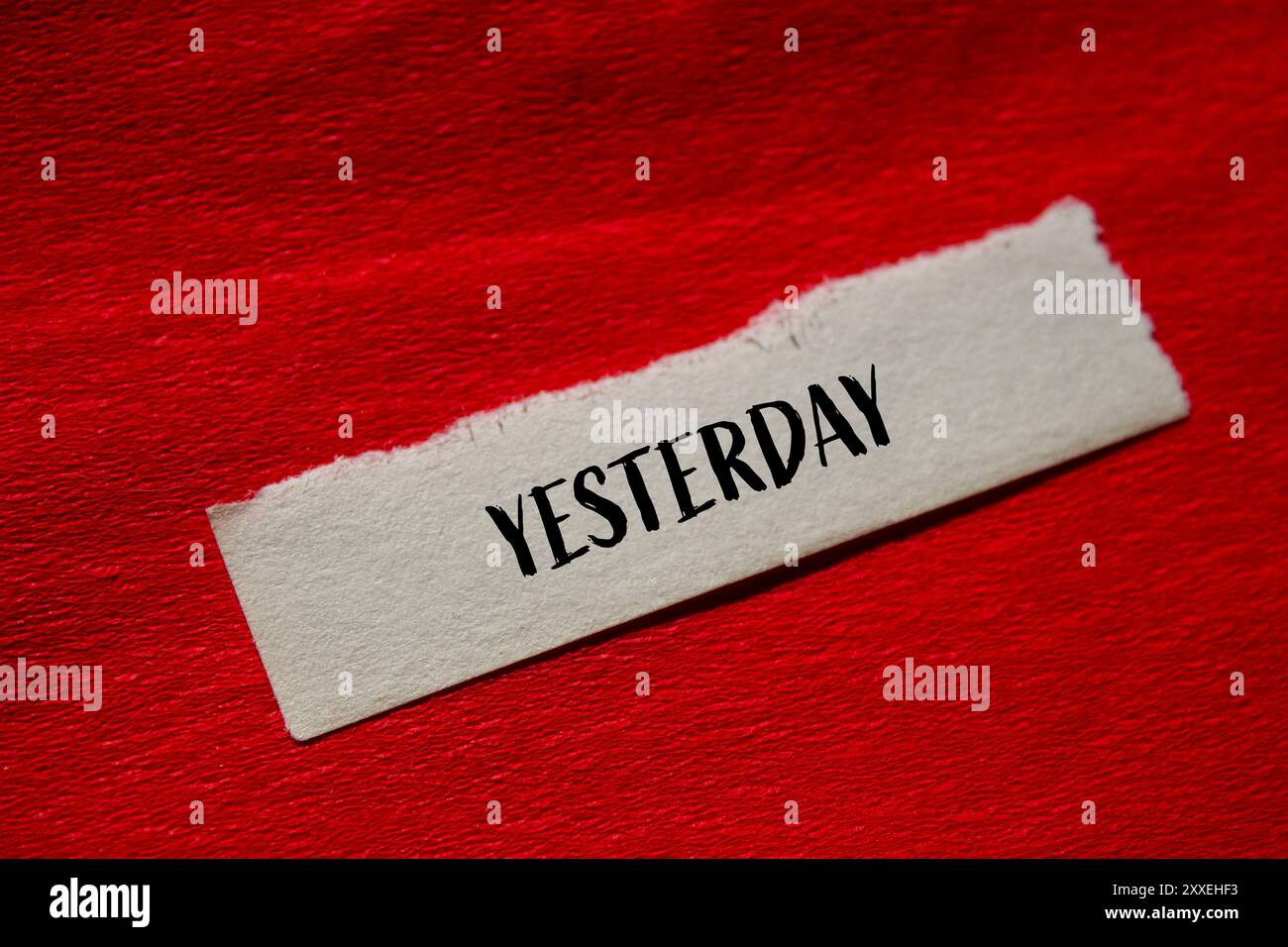 Yesterday word written on torn paper with red background. Conceptual ...