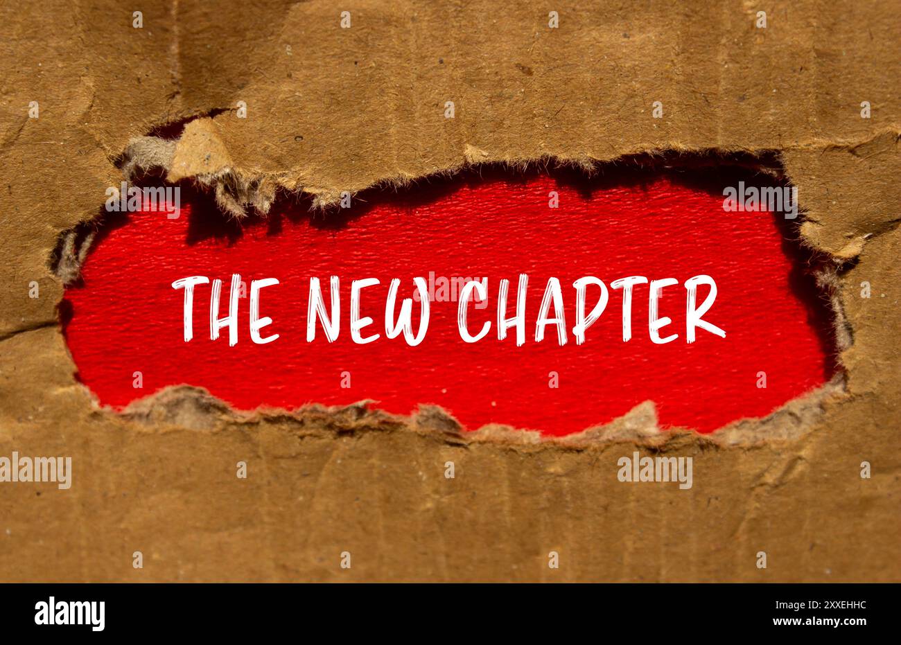 The new chapter message written on torn cardboard paper with red ...