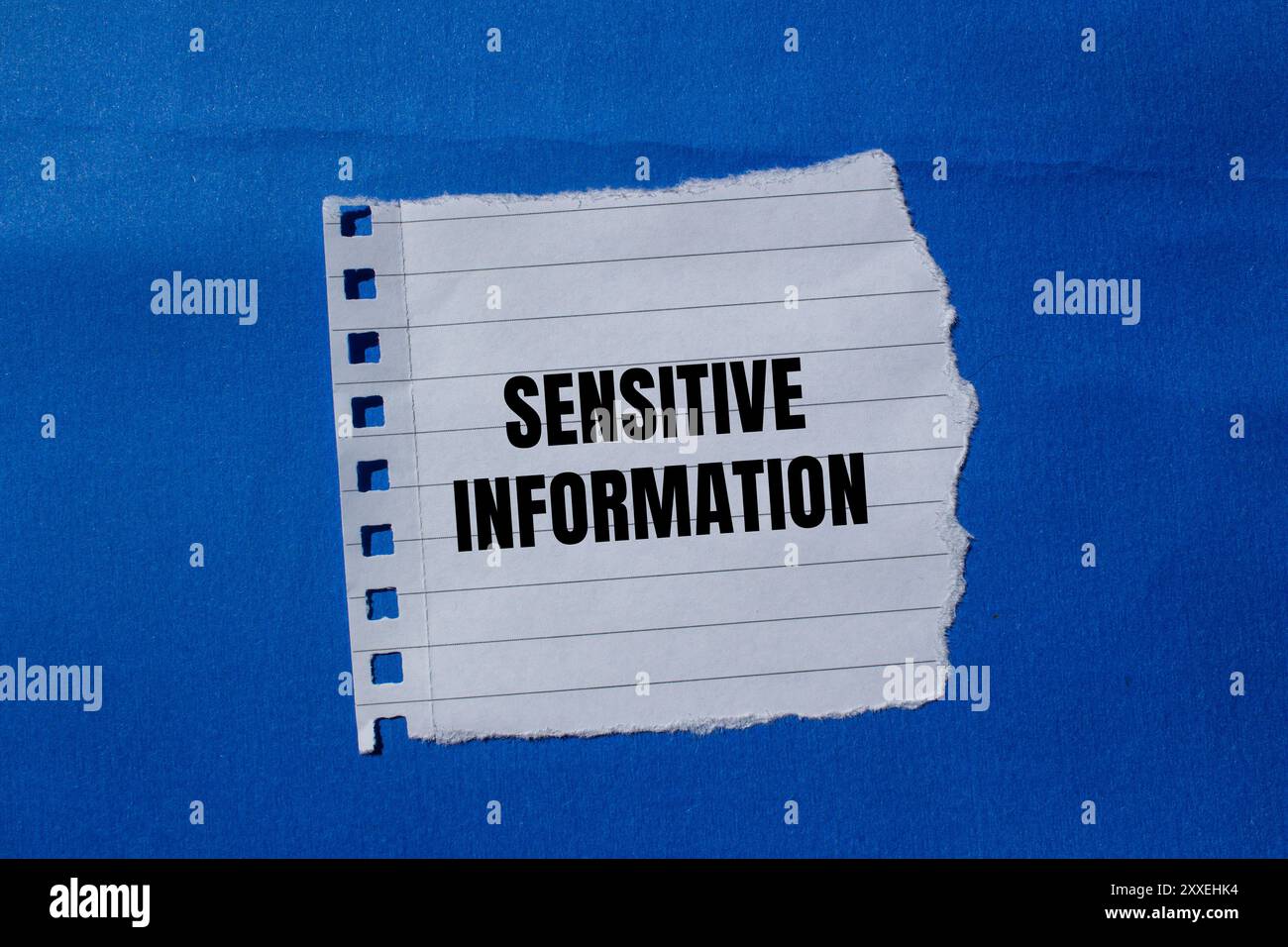 Sensitive information message written on ripped torn paper piece with ...