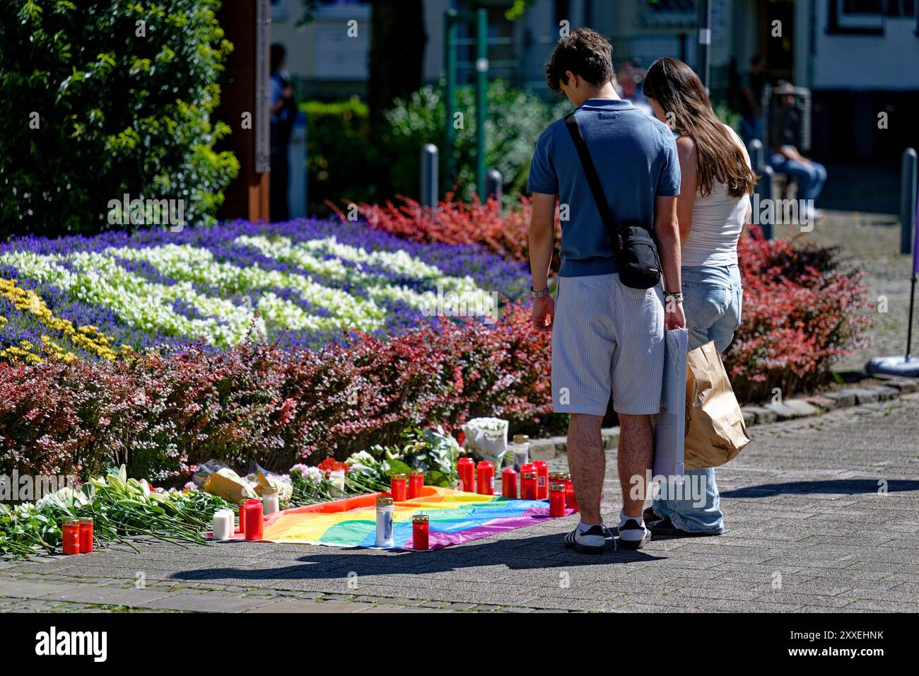 People lay flowers near the scene of a knife attack in Solingen city ...