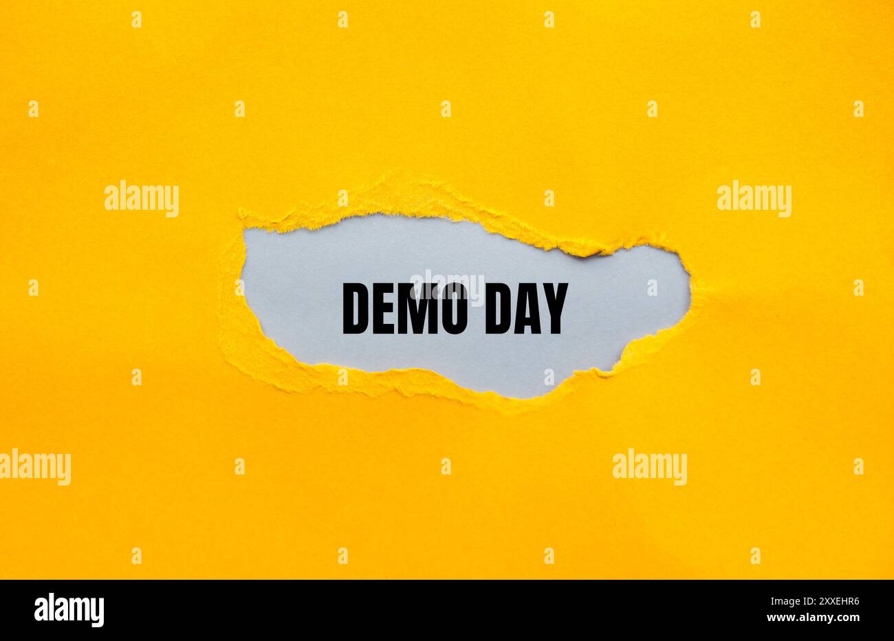 Demo day message written on ripped yellow torn paper with gray ...