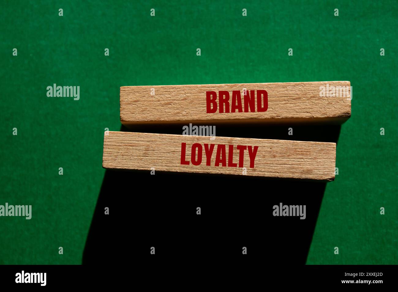 Brand loyalty message written on wooden blocks on green background ...