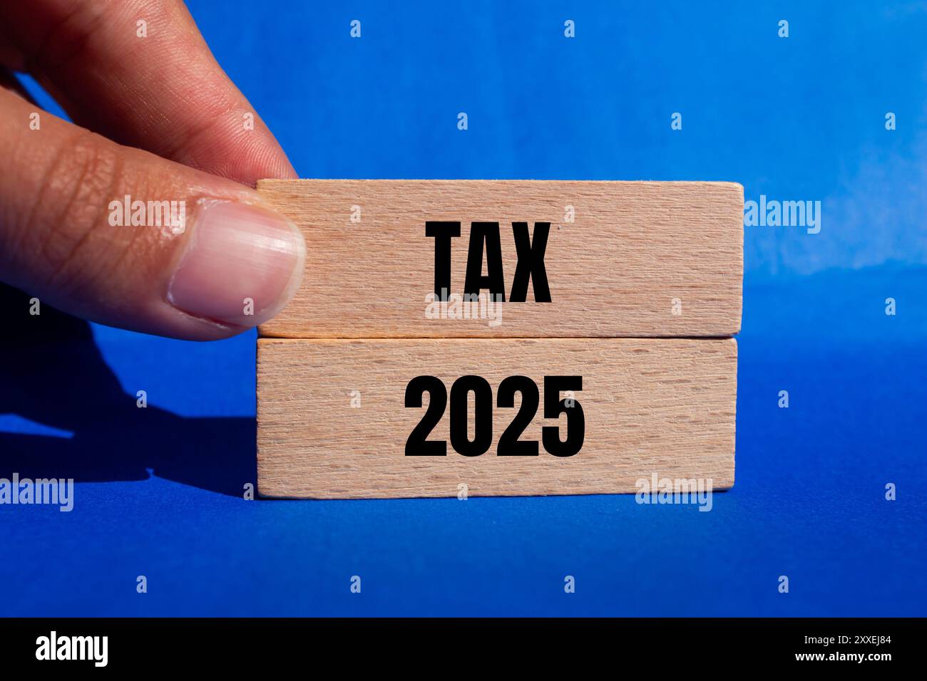 Tax 2025 message written on wooden blocks with blue background ...