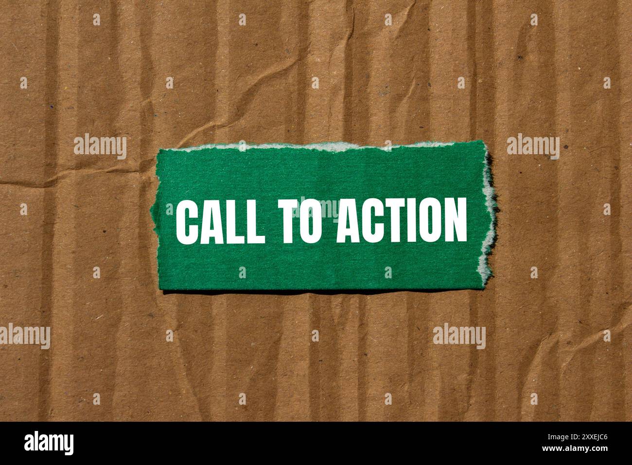Call to action message written on ripped torn green paper piece with ...