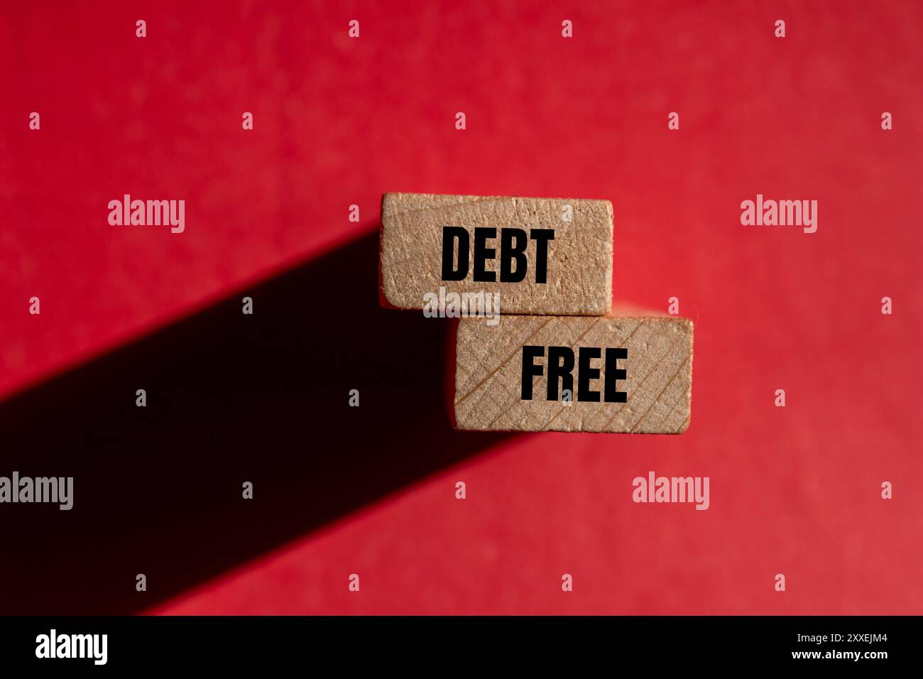 Debt free message written on wooden blocks with red background ...