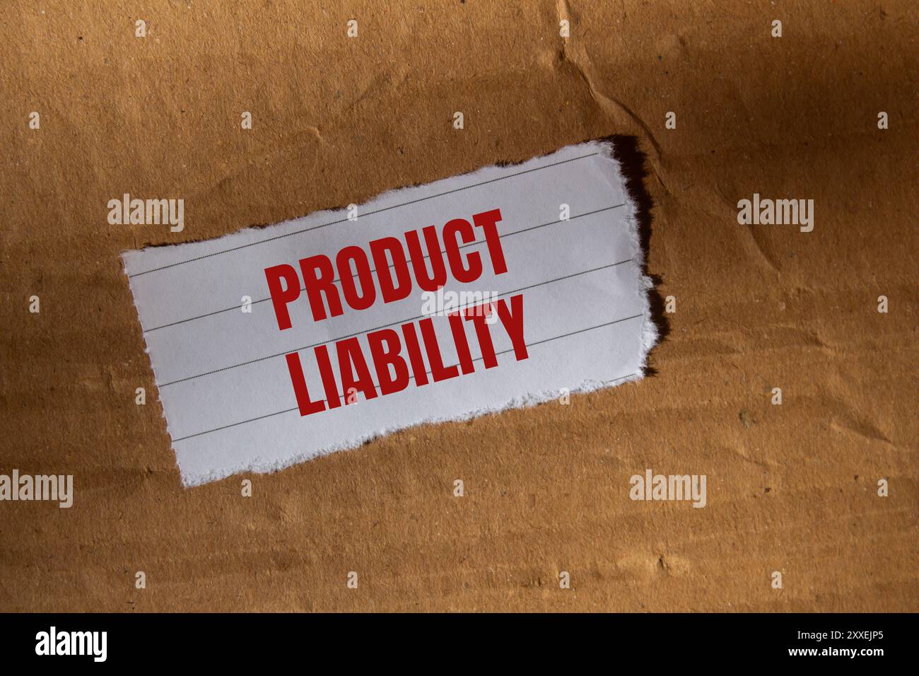 Product liability message written on ripped torn white paper piece with ...
