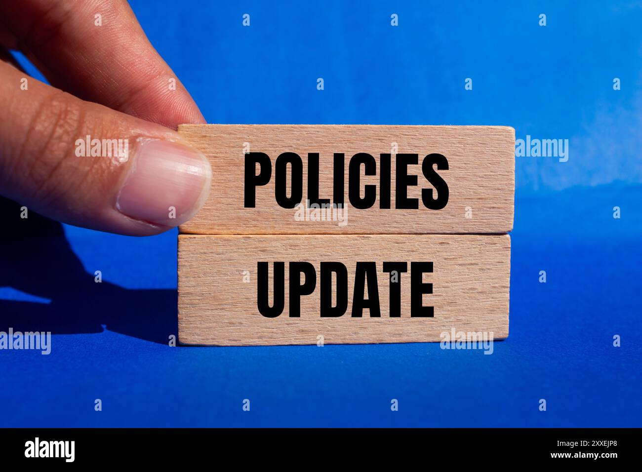 Policies update message written on wooden blocks with blue background ...