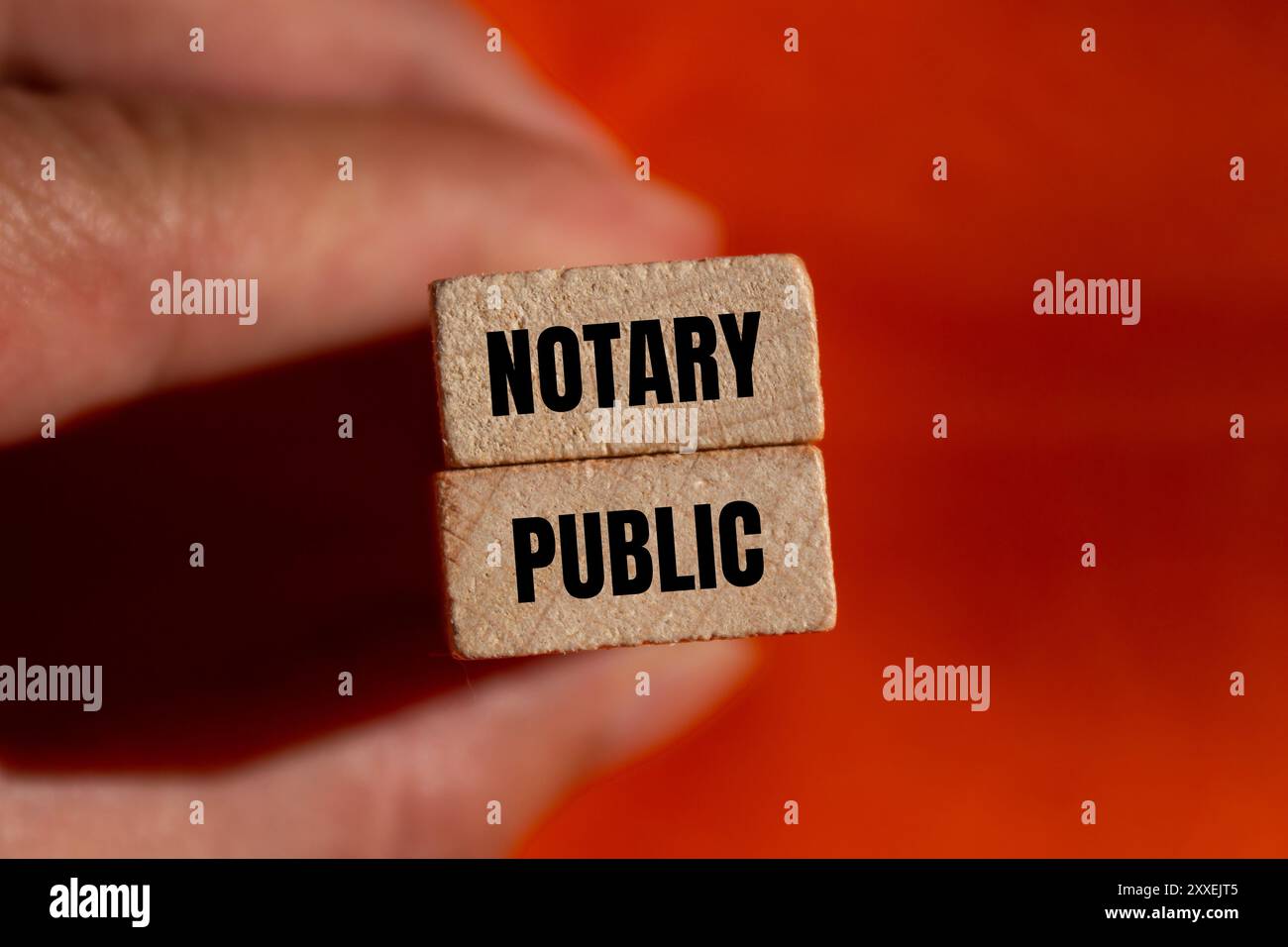Notary public message written on wooden blocks with orange background ...