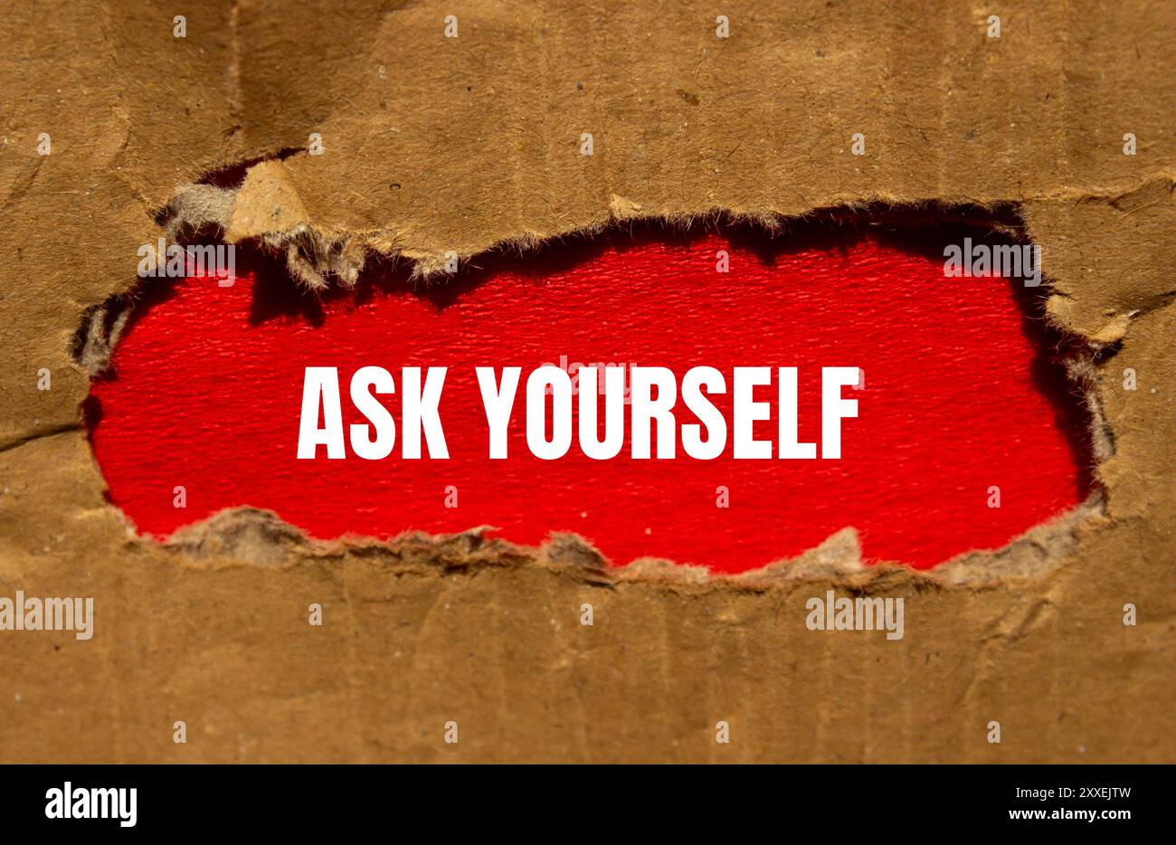 Ask yourself message written on torn cardboard paper with red ...