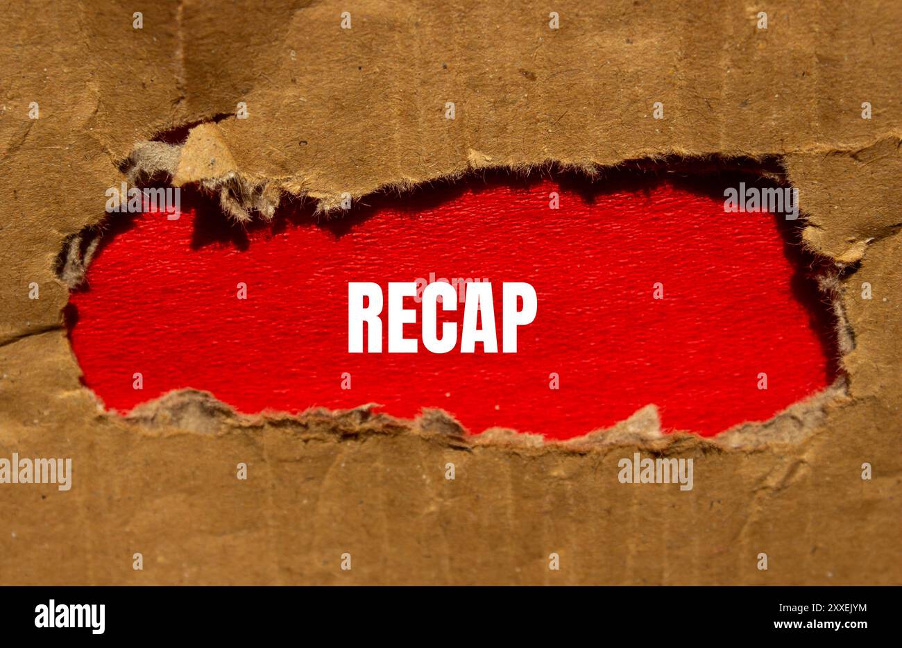 Recap message written on torn cardboard paper with red background. Conceptual recap symbol. Copy ...