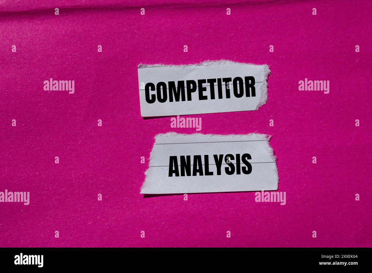 Competitor analysis message written on ripped torn paper pieces with ...