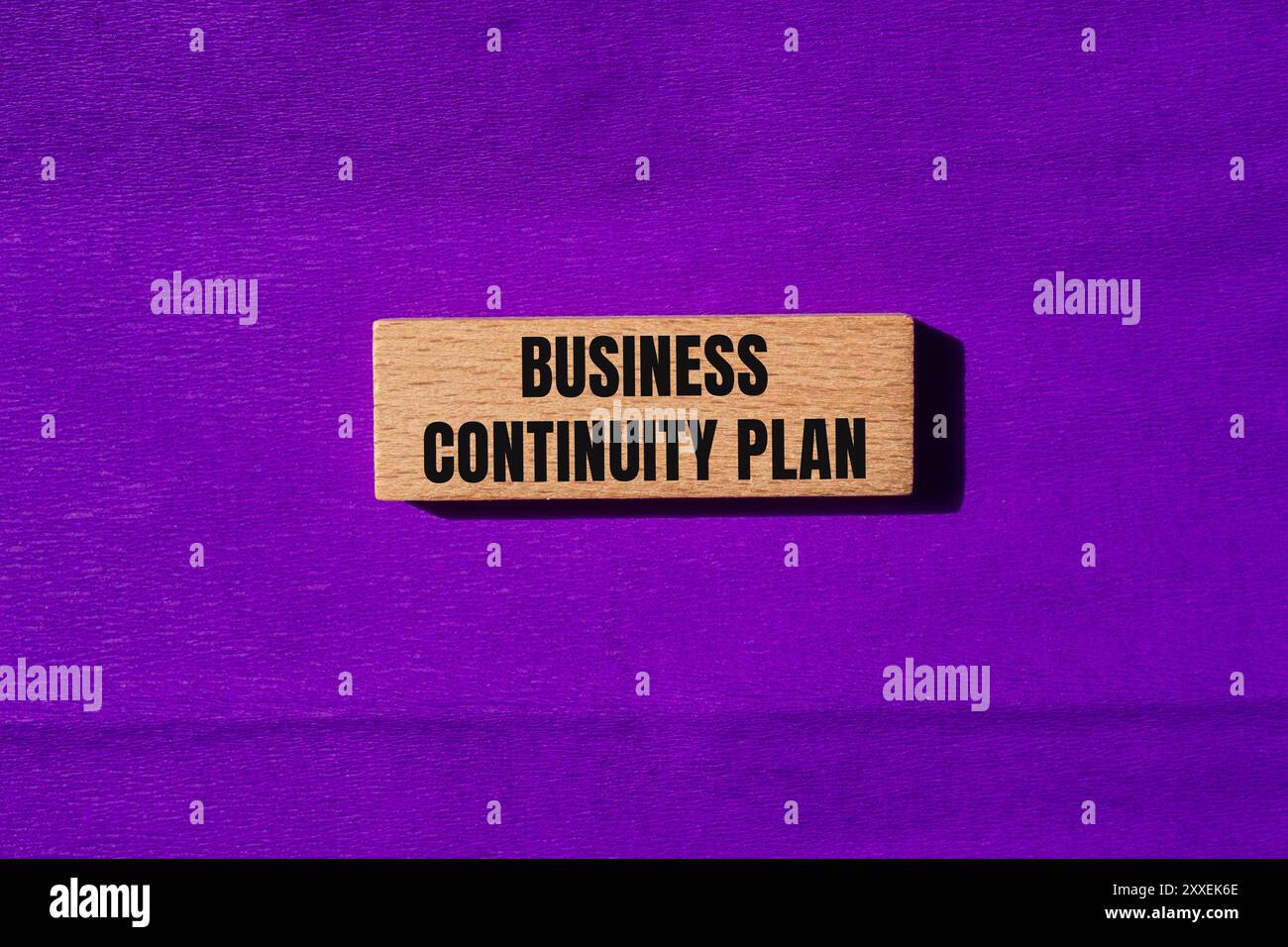 Business continuity plan message written on wooden blocks with purple ...